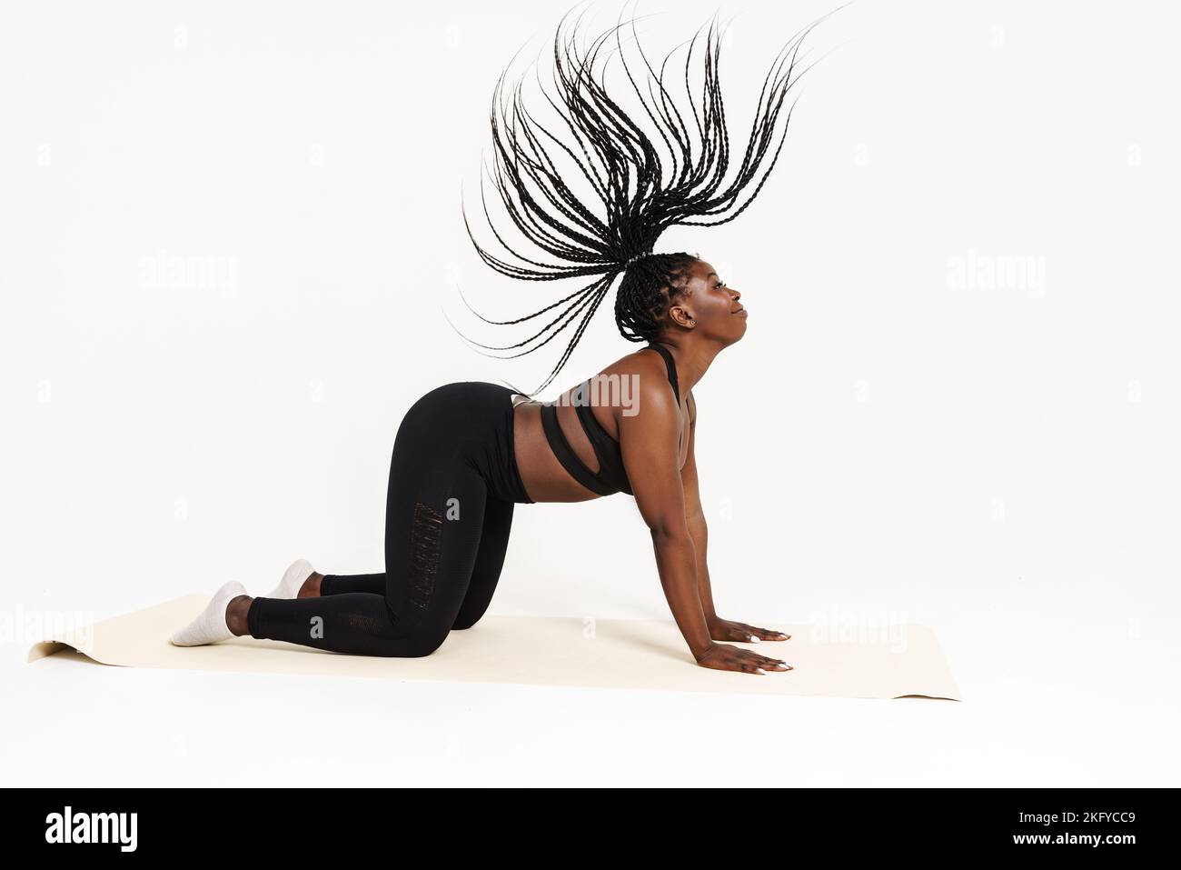 Black young woman standing in pose during yoga practice isolated over ...