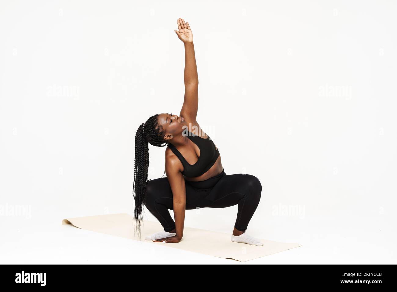 Black young woman standing in pose during yoga practice isolated over ...