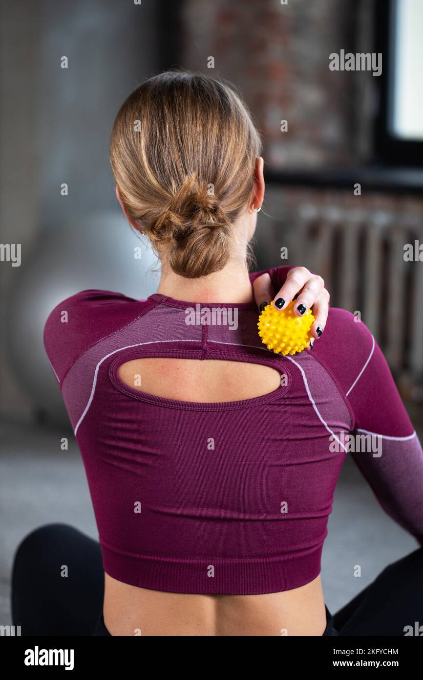 The athlete does a relaxing massage of the neck and back with the help ...