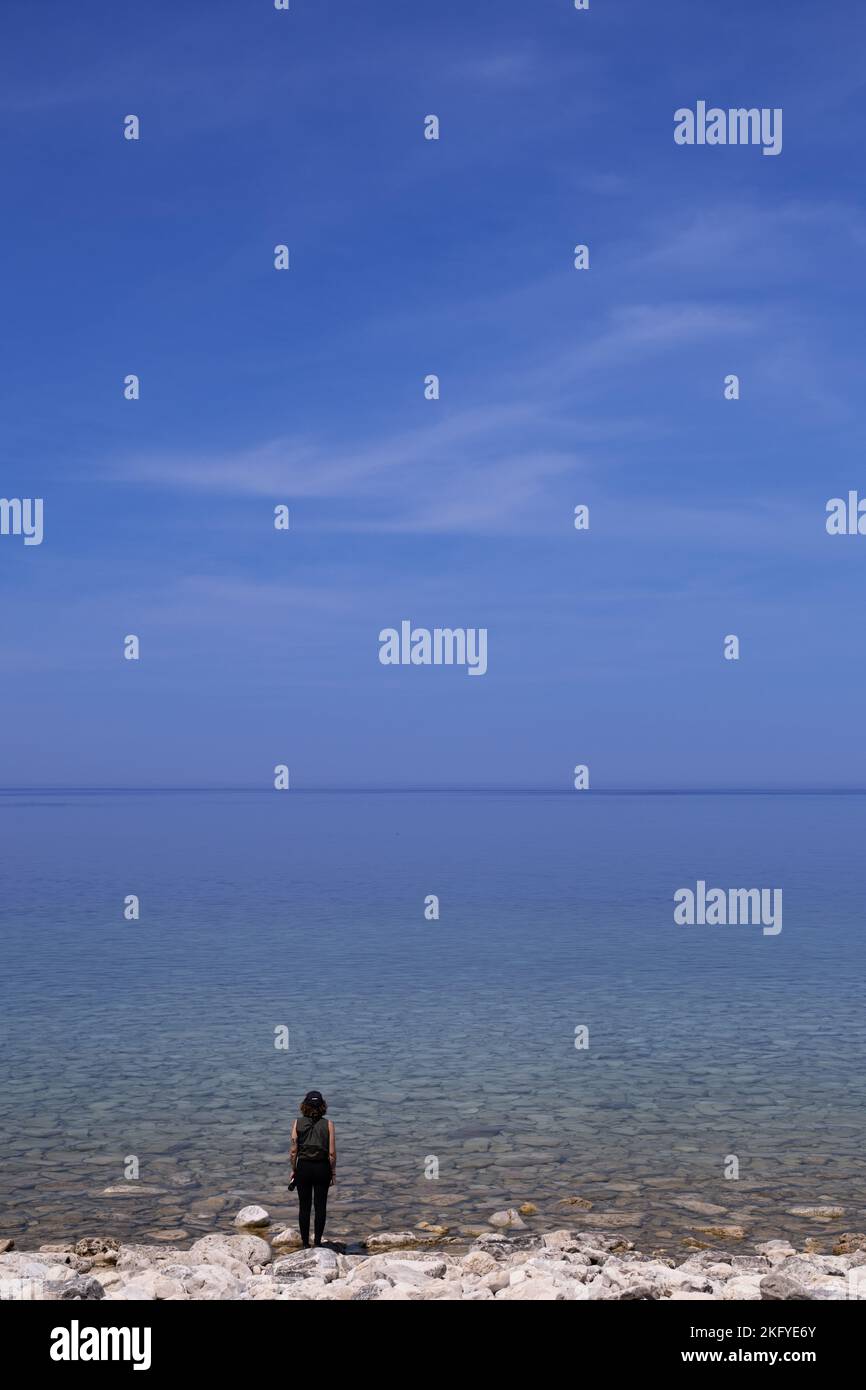 woman looking at the horizon on a paradise beach Stock Photo - Alamy