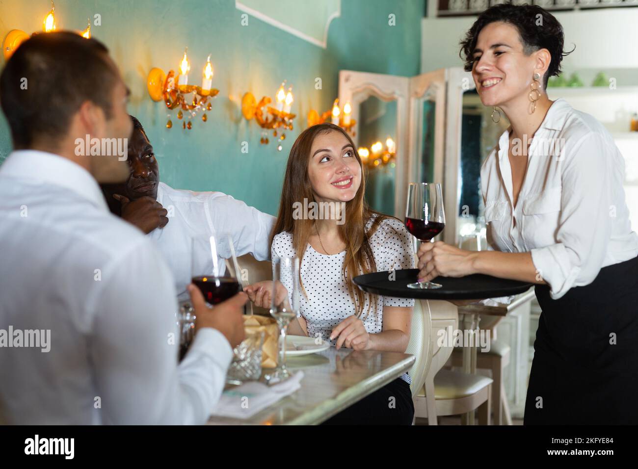 Waitress serving couple at the restaurant Stock Photo - Alamy