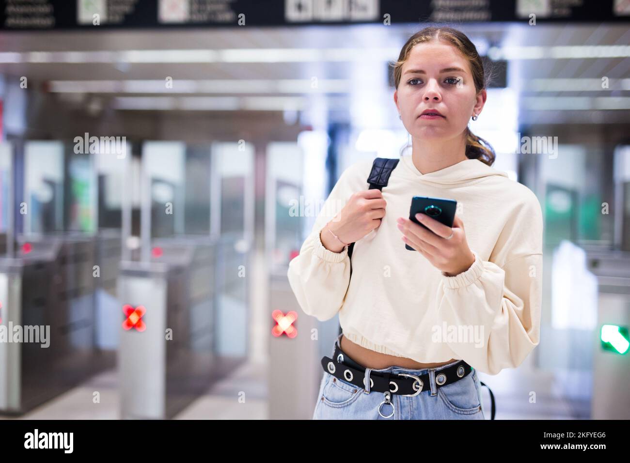 Younh female passing the turnstiles at subway station Stock Photo - Alamy