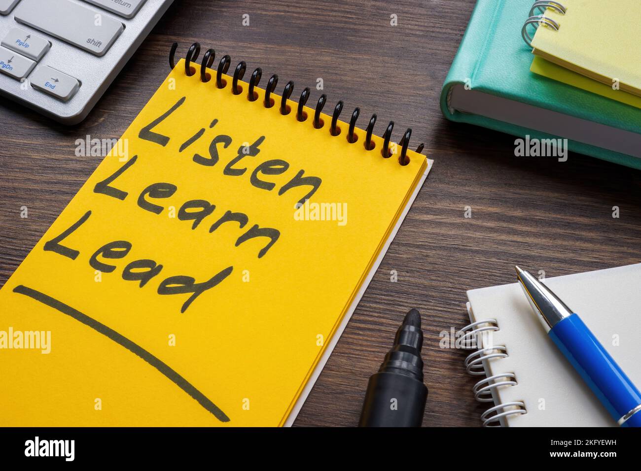 Marks in the yellow notepad. Listen, learn and lead Stock Photo - Alamy