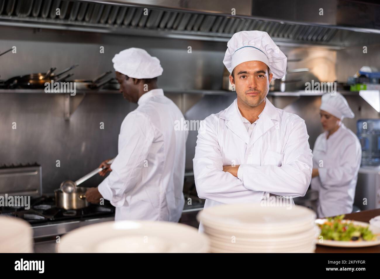 Portrait of chef with arms crossed in restaurant kitchen Stock Photo ...