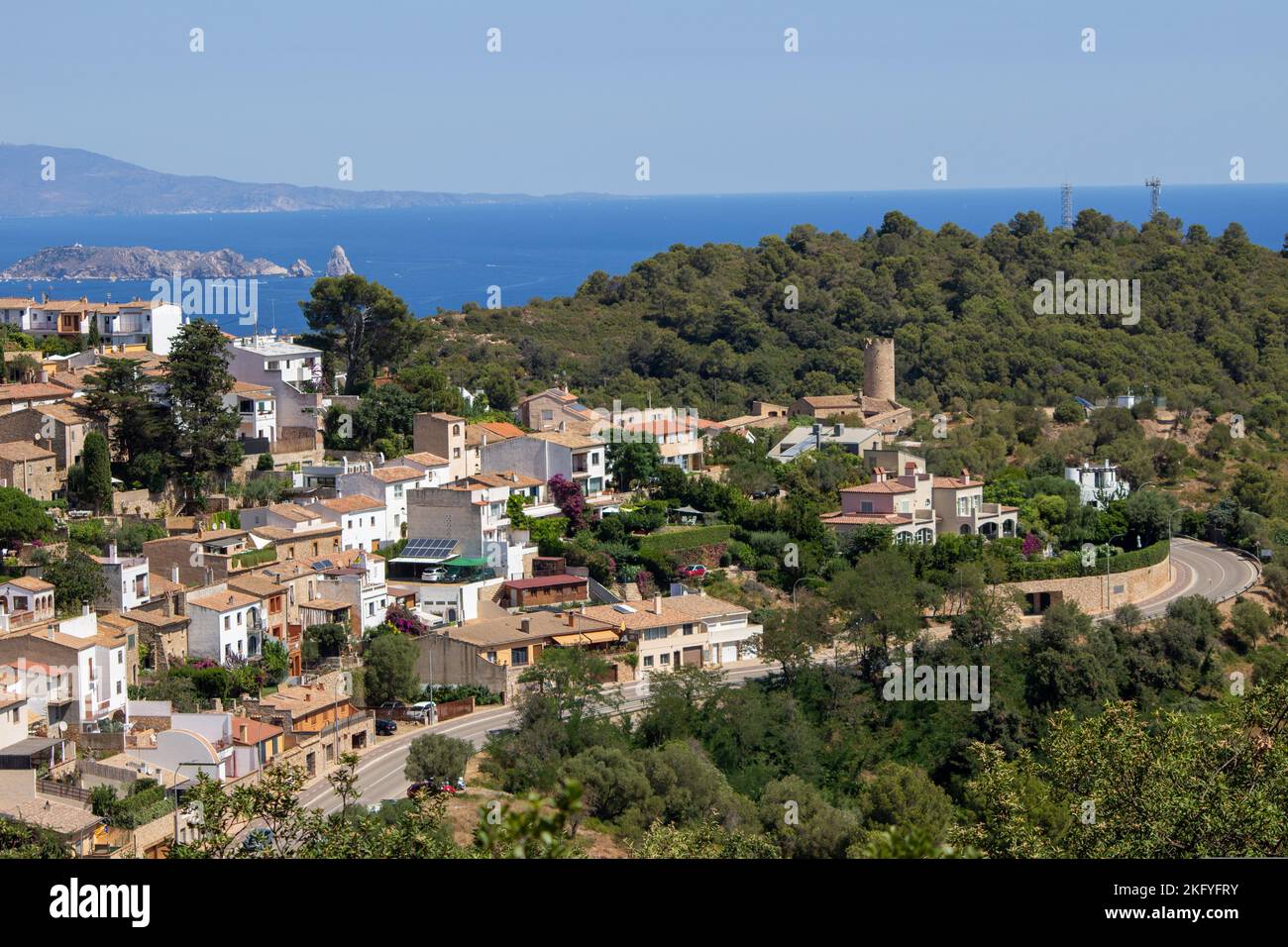 A beautiful view of the city of Begur in Spain with buildings and thick ...