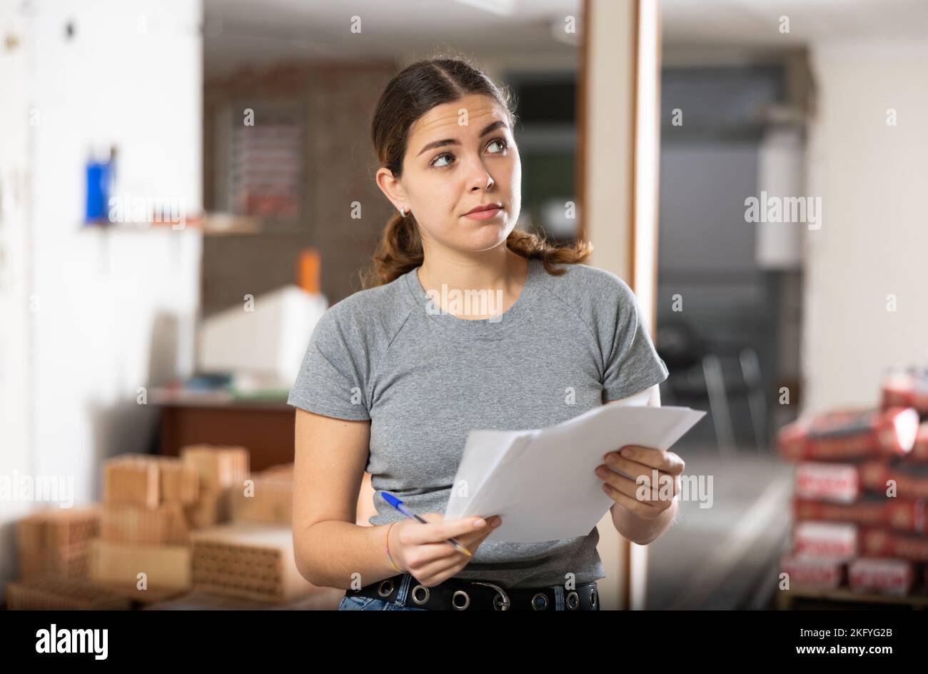 Female architect checking documents in construction site Stock Photo - Alamy
