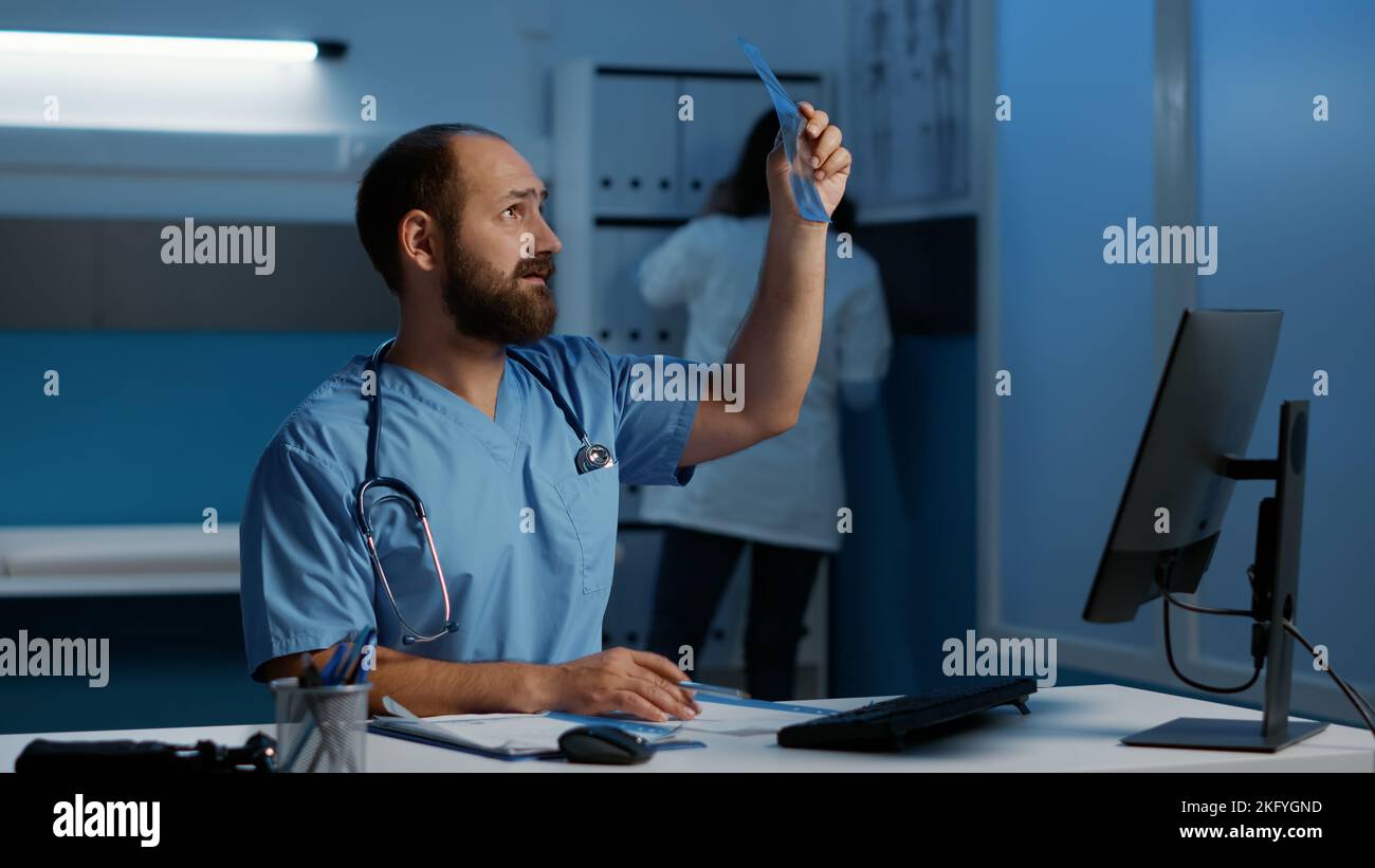 Doctor nurse analyzing patient lungs radiography typing medical ...