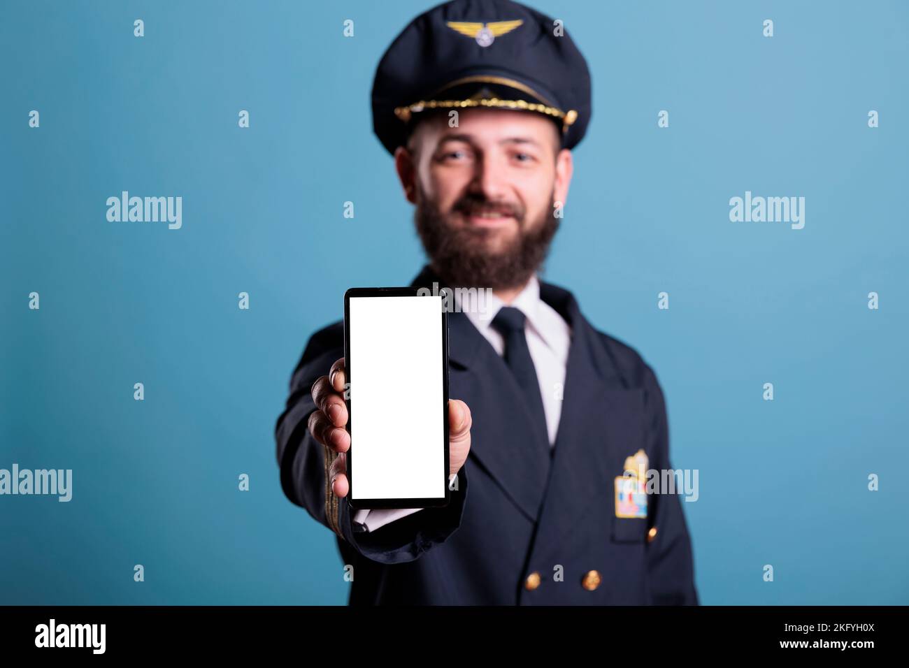 Airplane pilot showing smartphone with blank white screen close up ...