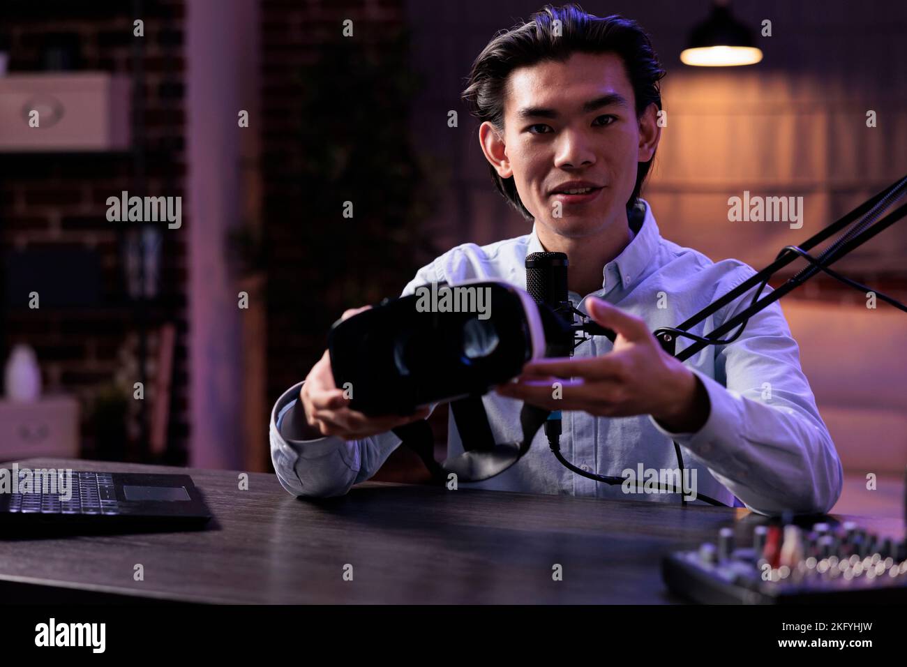 Lifestyle vlogger filming product review video with headphones ...