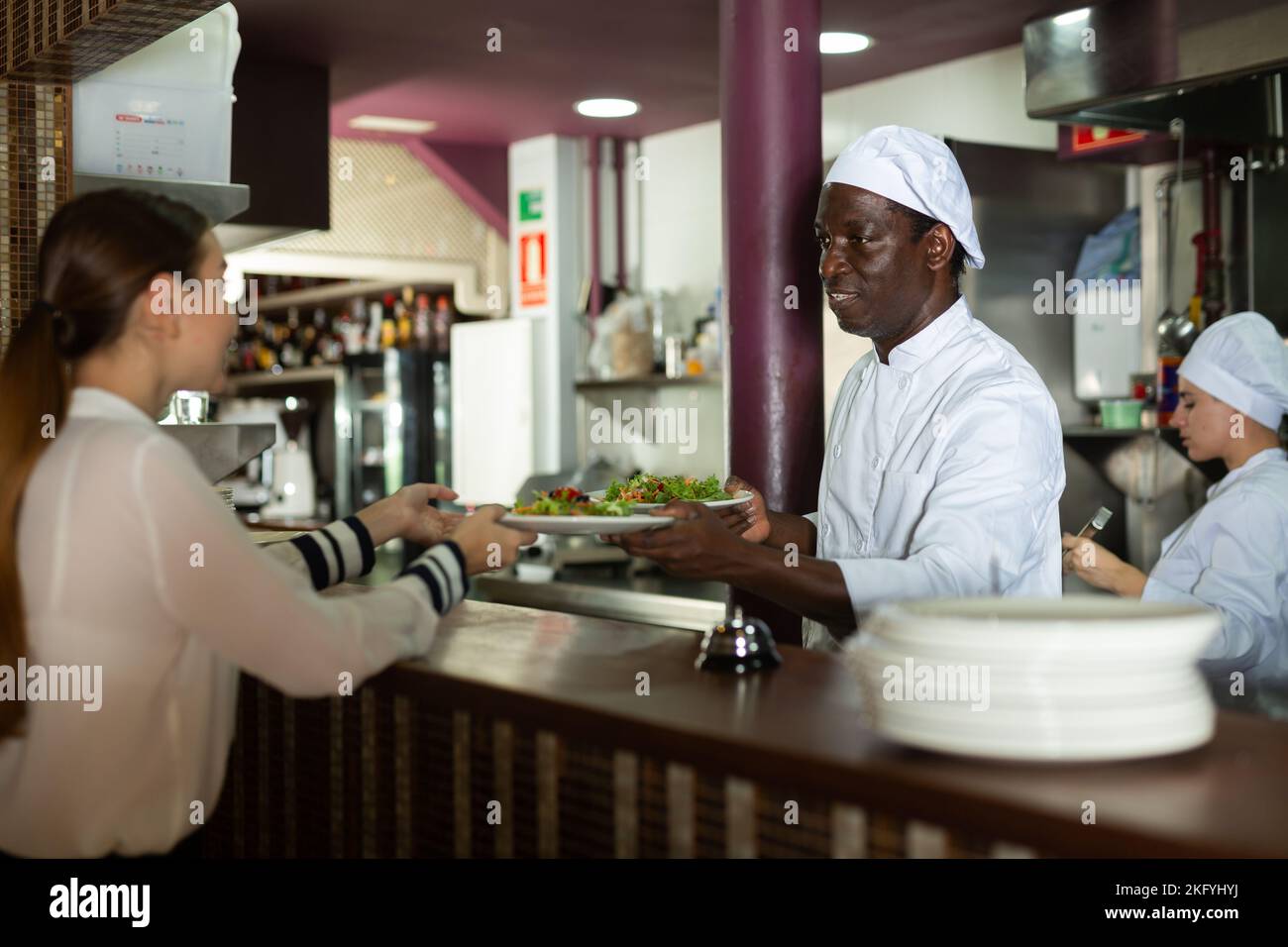 African american chef serving ready tasty meals to visitors of ...