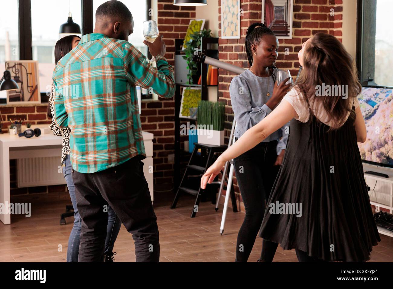 Culturally diverse couples of friends, mates gladly dancing, drinking ...