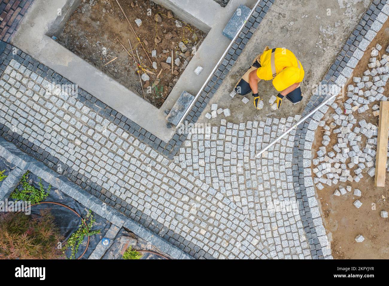 Professional Contractor Building Garden Brick Walkway of Granite Pavers ...