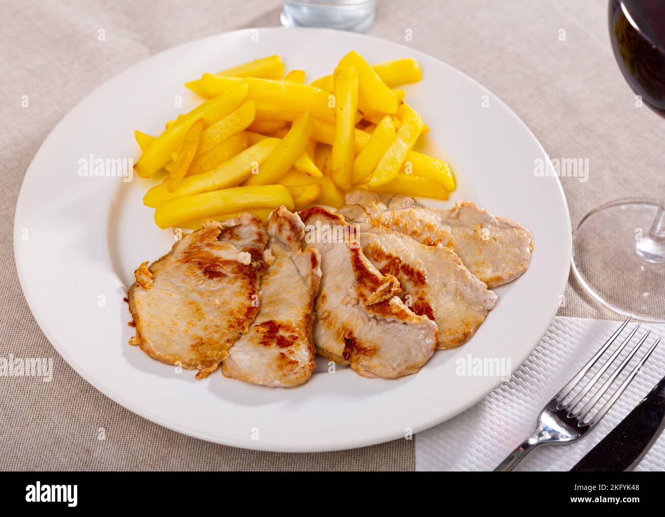 Fried pork fillets with side dish of French fries Stock Photo - Alamy