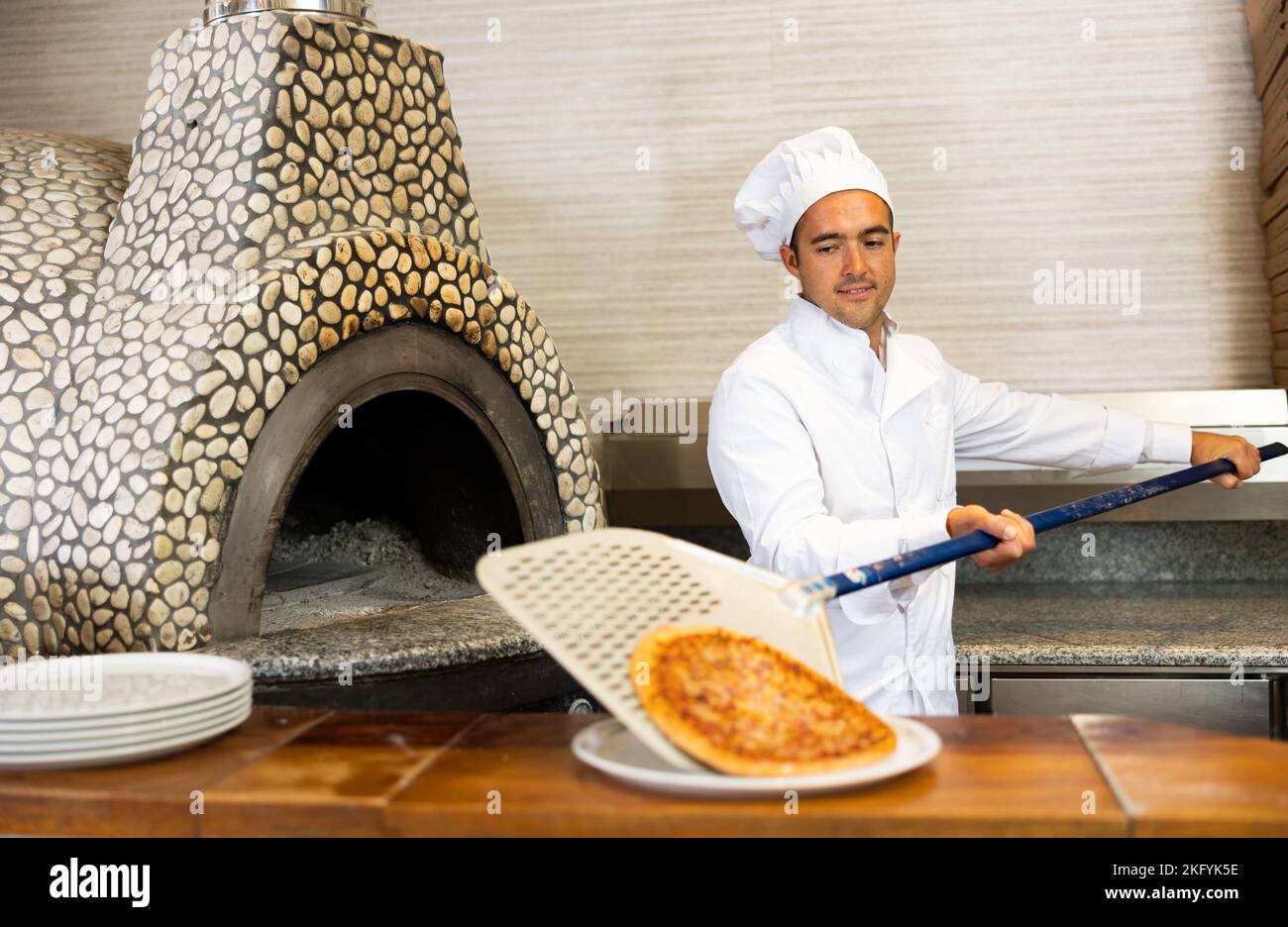 Skilled man chef preparing pizza in restaurant Stock Photo - Alamy