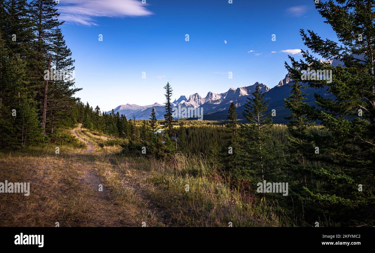 Rocky Mountain landscape with road and fields in foreground at dusk in ...
