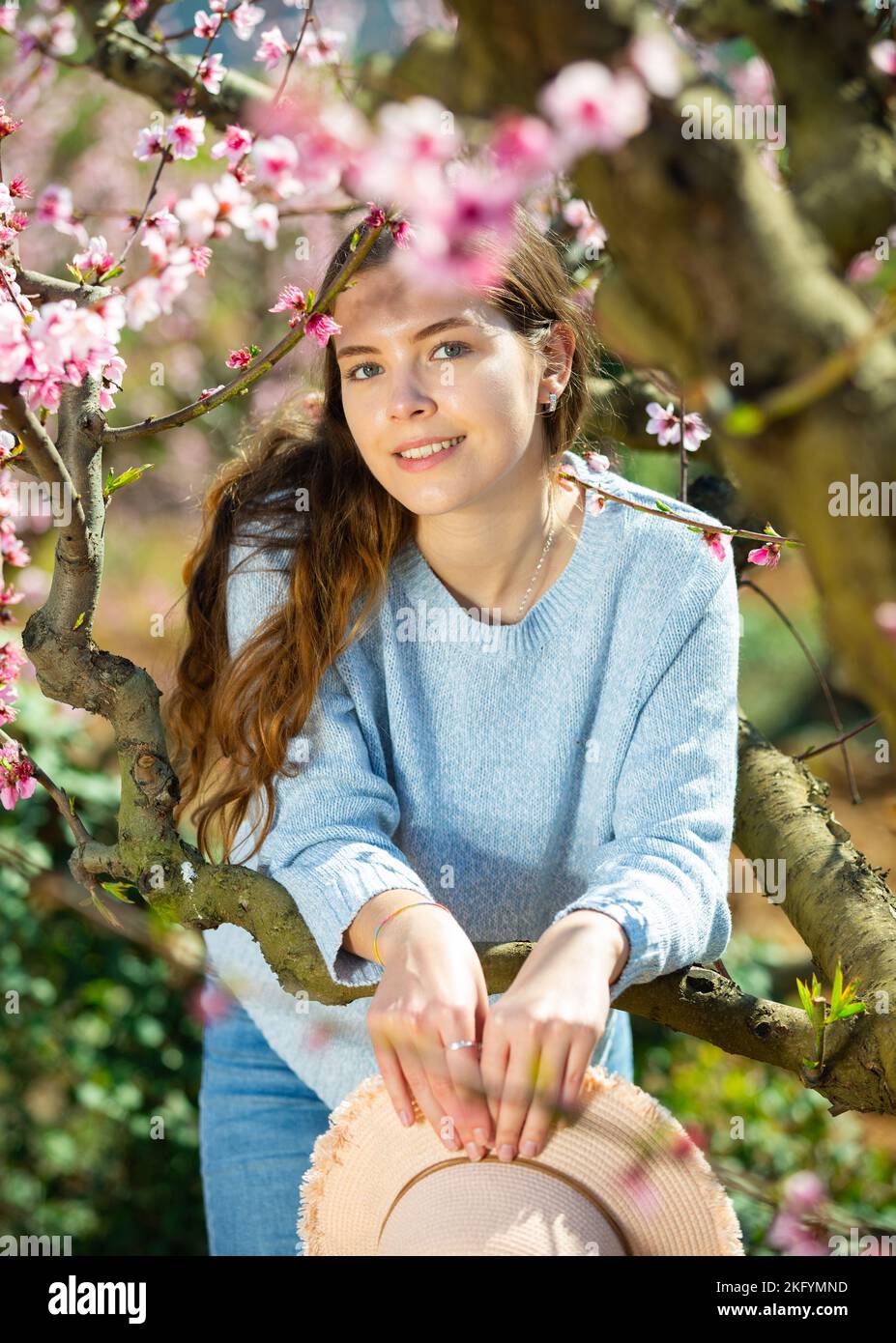 Woman standing under trees hi-res stock photography and images - Alamy