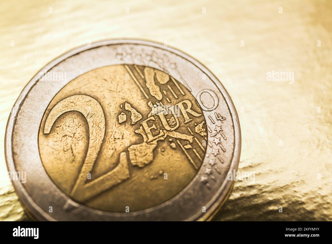 Two Euros coin on gold background Stock Photo - Alamy