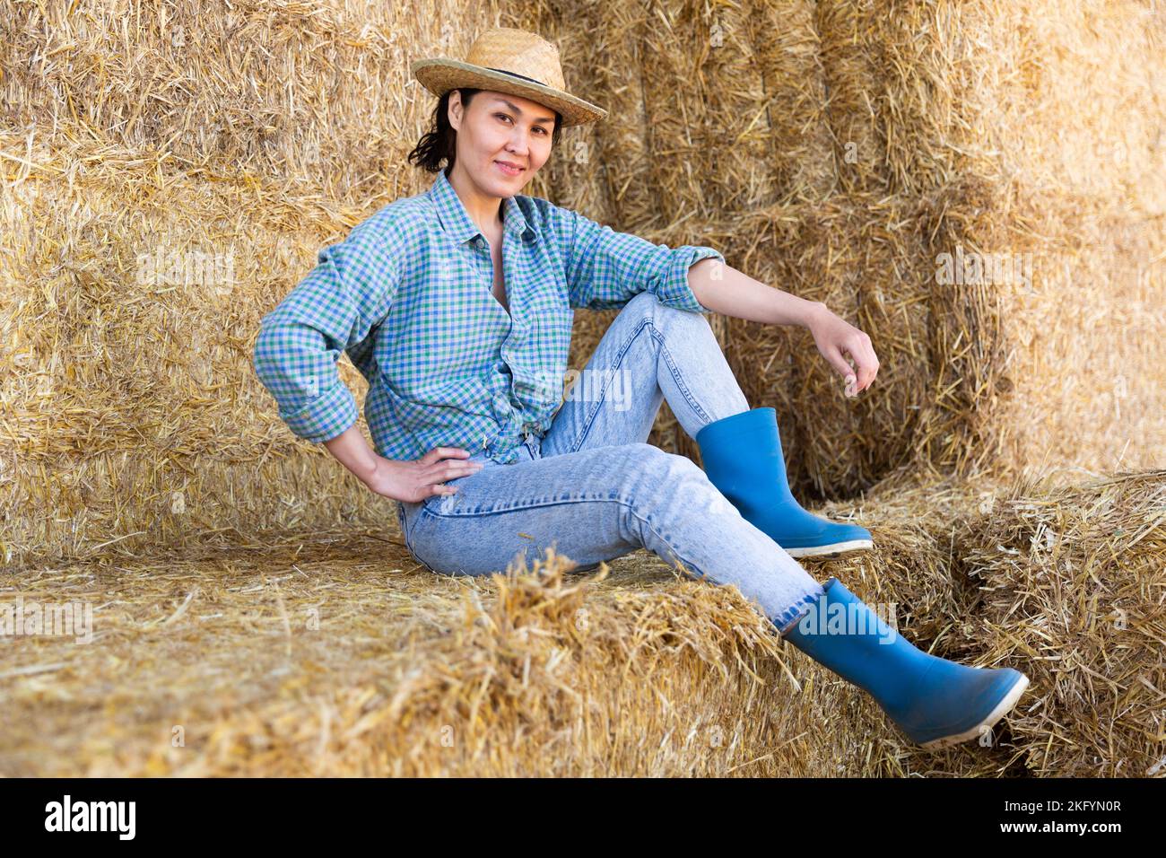 Woman posing at hay storage on farm Stock Photo - Alamy