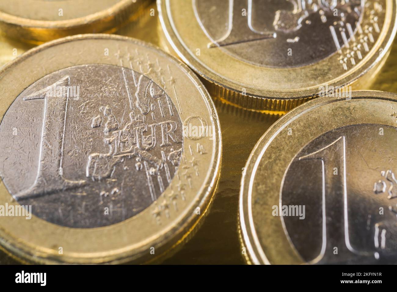 One Euro coins on gold background Stock Photo - Alamy