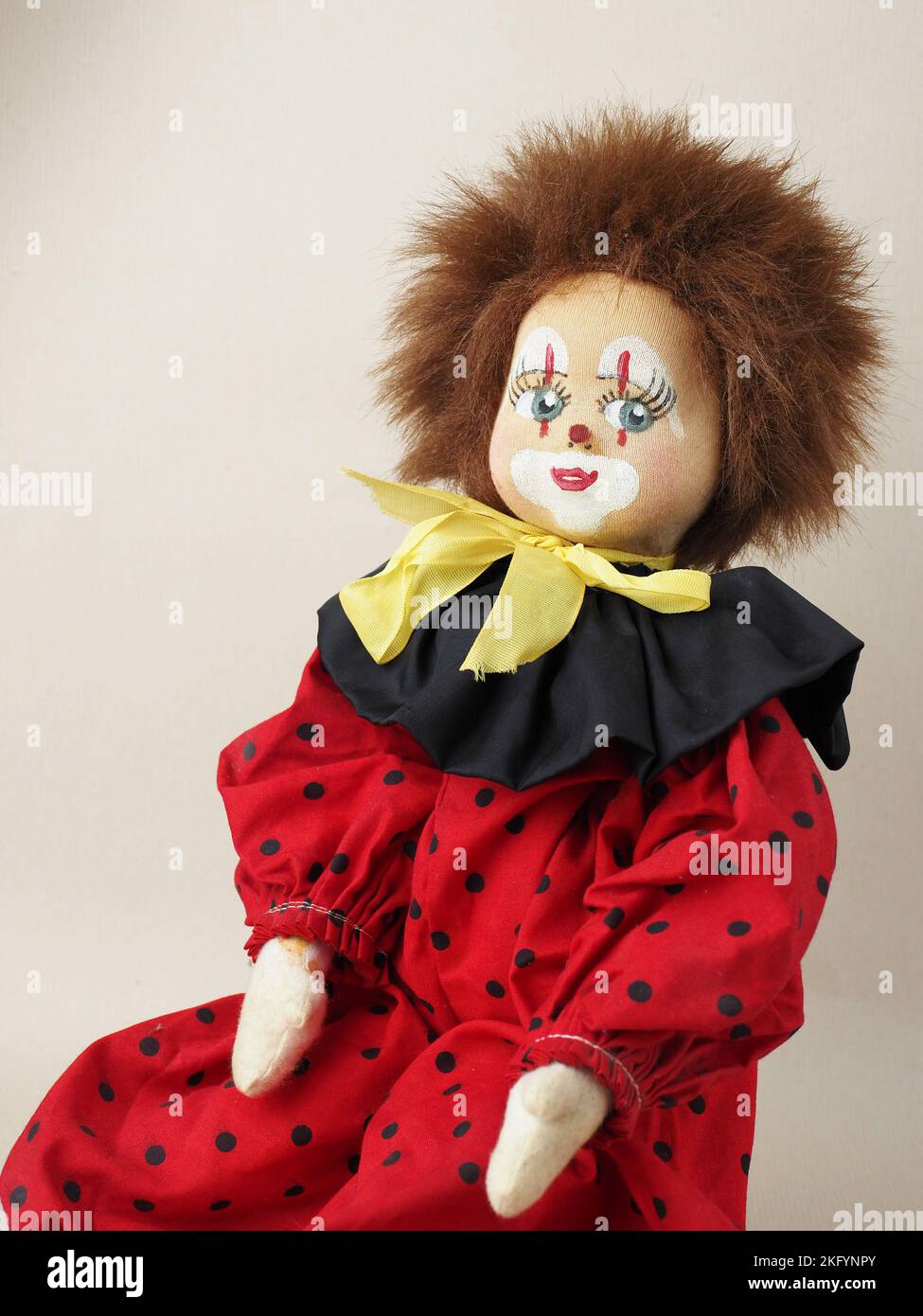 In this photo illustration, a vintage red-haired clown doll in a red ...