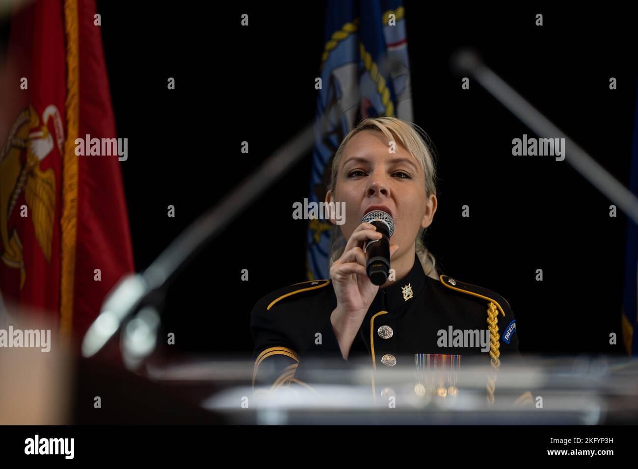 Army Specialist 1st Class Nicole Bouffard sings the national anthem ...