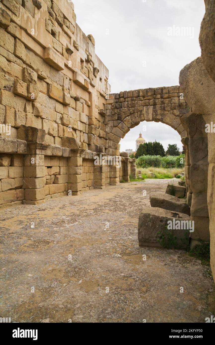 Cut stone walls and arch at the Roman ruins in the town of Tindari ...
