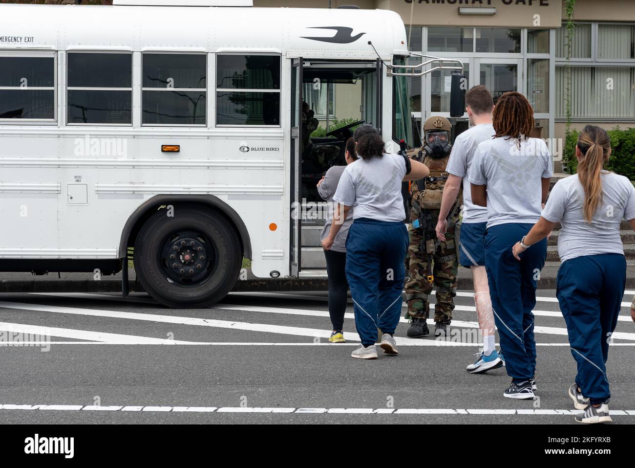 Simulated victims line up to get on a bus during a mass casualty ...