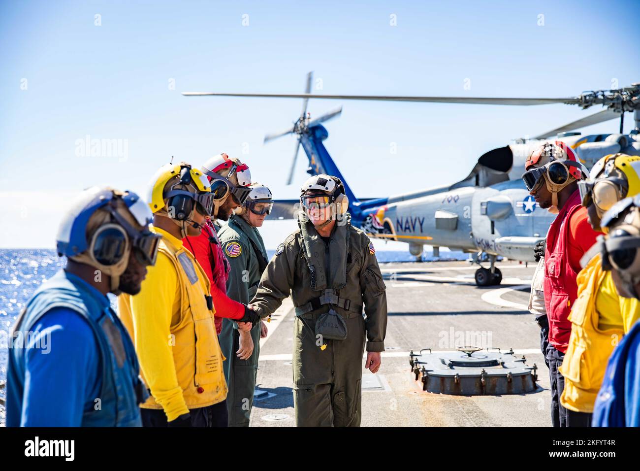 Rear Adm. Greg Huffman, Commander, Carrier Strike Group 12, center ...