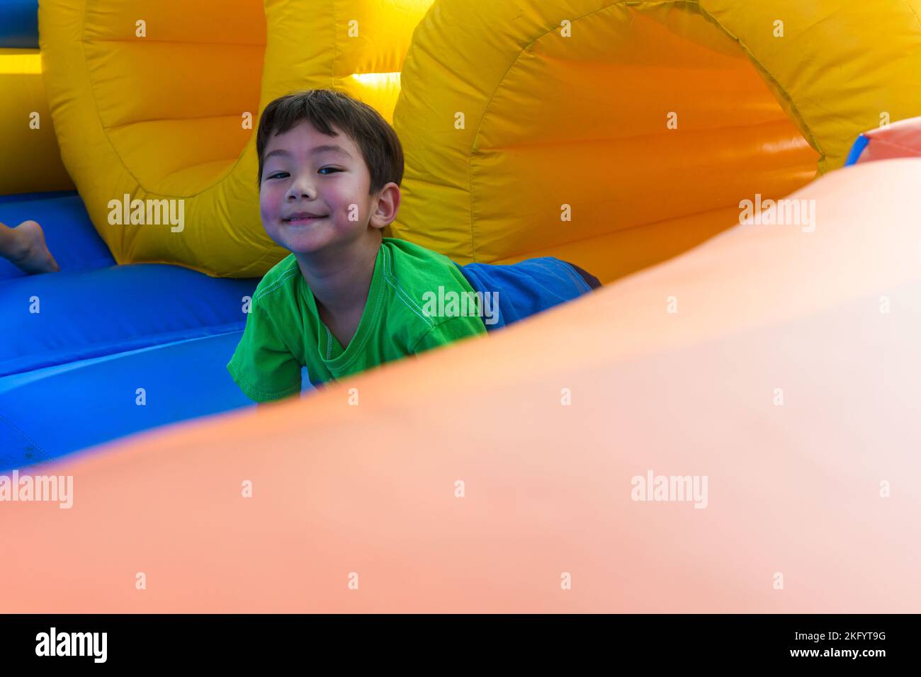 Liam Bray crawls through the tunnel of the bouncy house during United ...