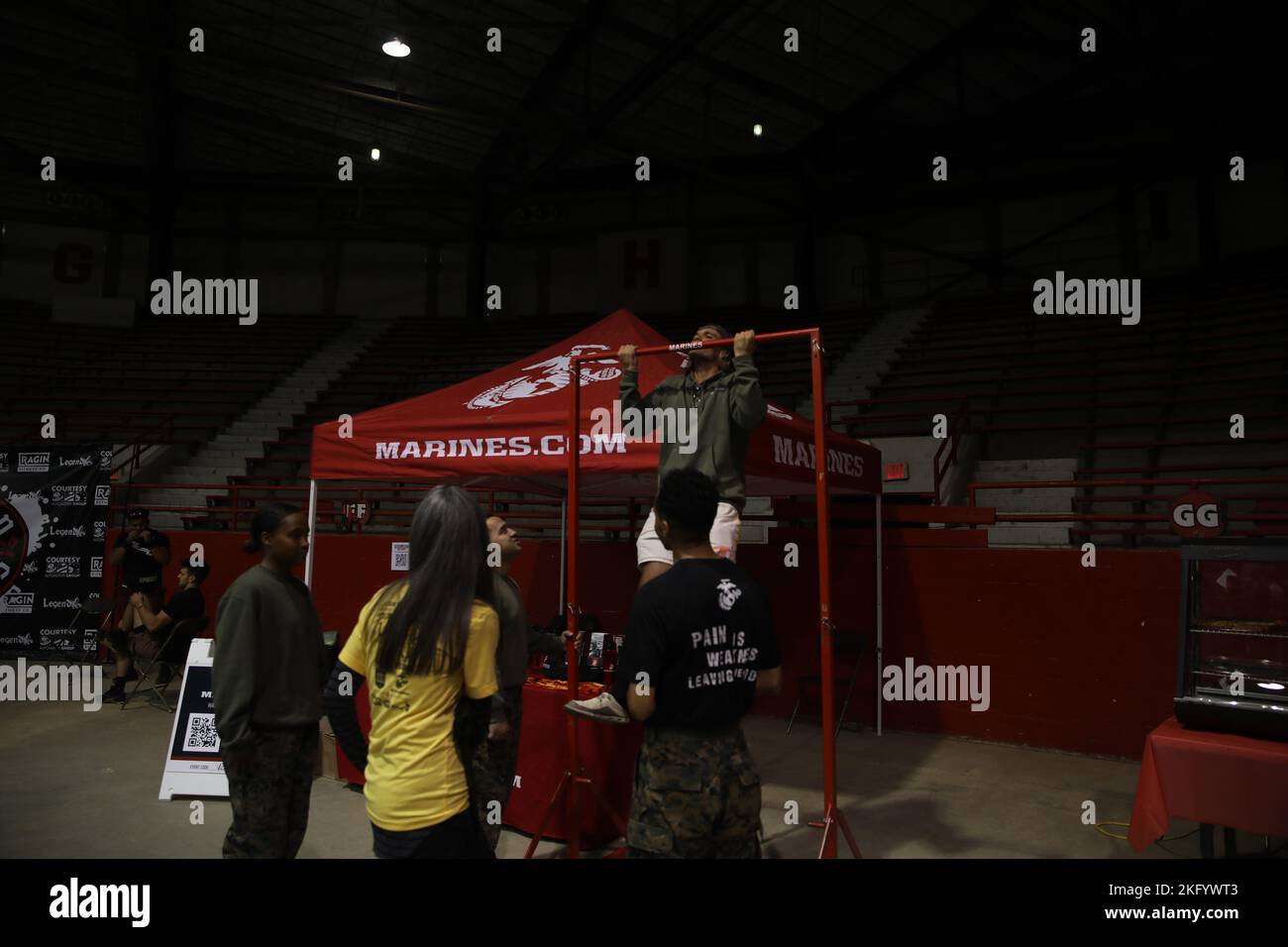 An attendee does some pullups to earn some U.S. Marine Corps gear ...