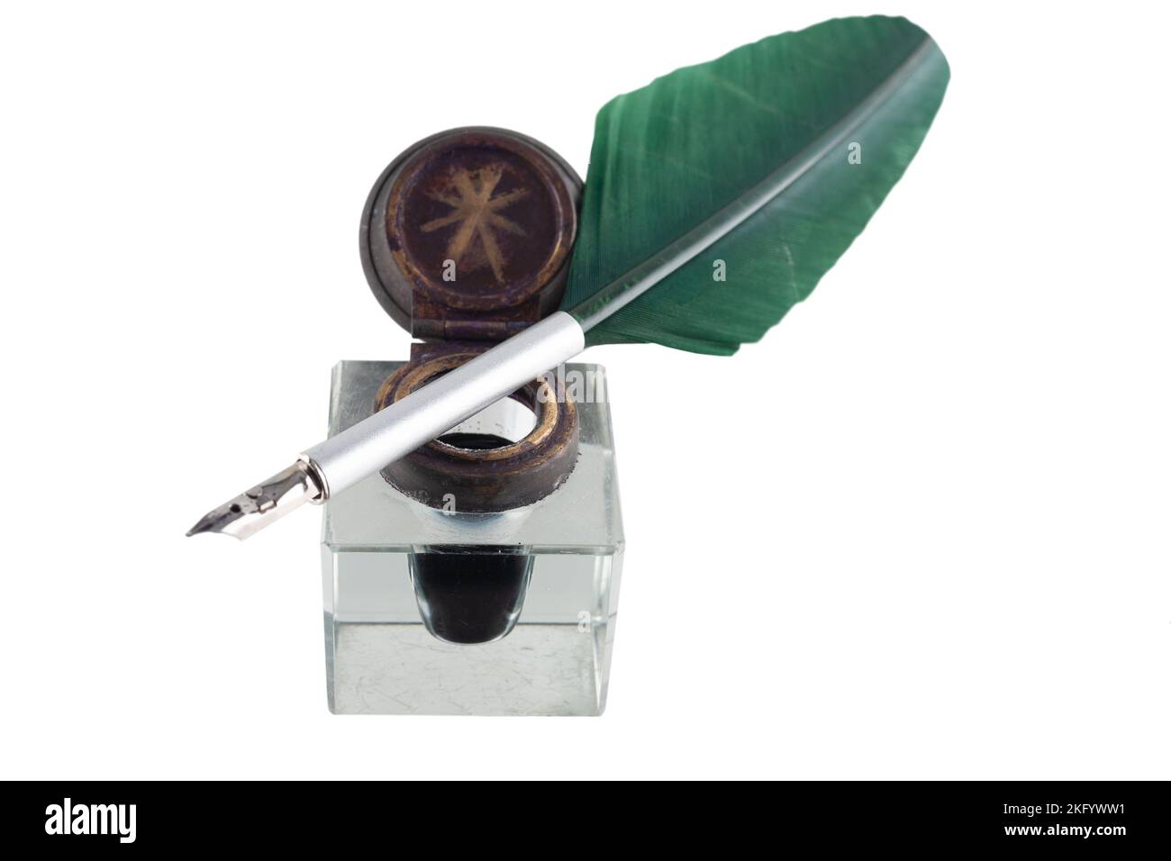 Antique vintage feather quill with glass inkwell isolated on white ...
