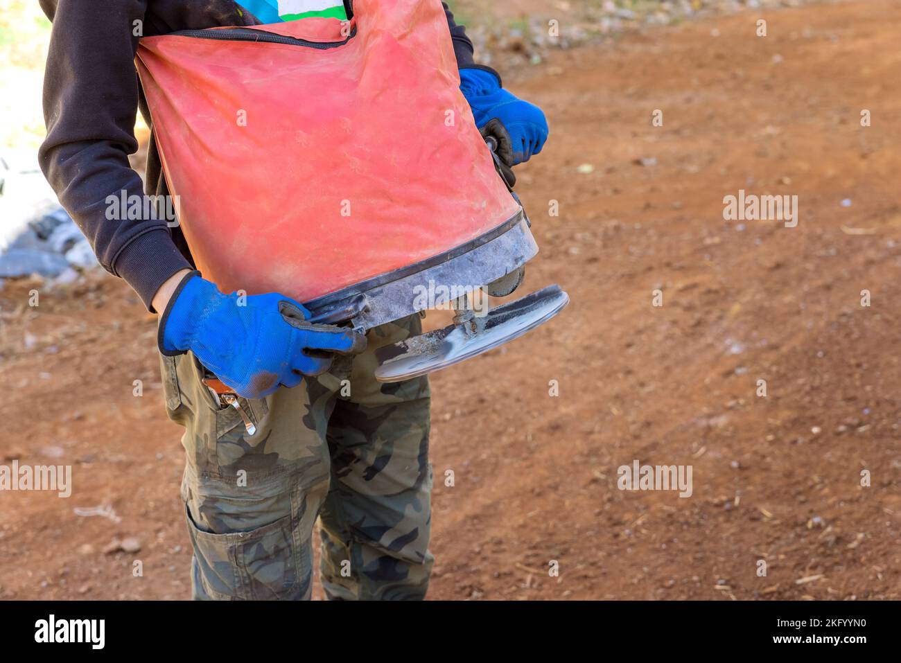 Landscapers work with gardeners to sow lawn grass seed using seeding ...
