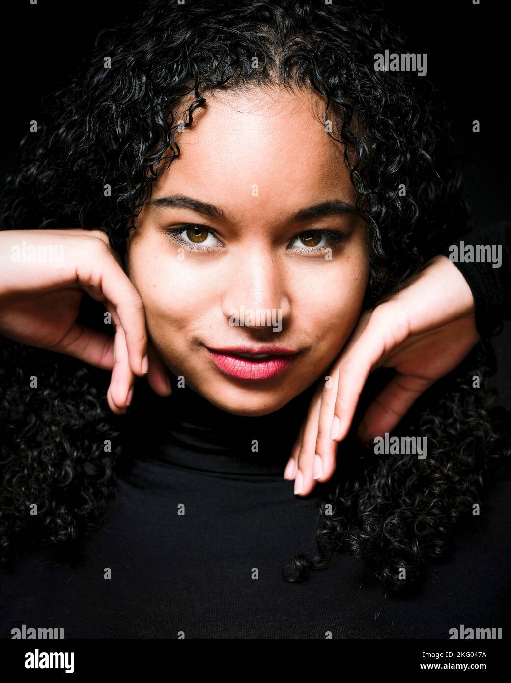 Young Woman with Hands at Cheeks | Intense Stare | Black Background ...