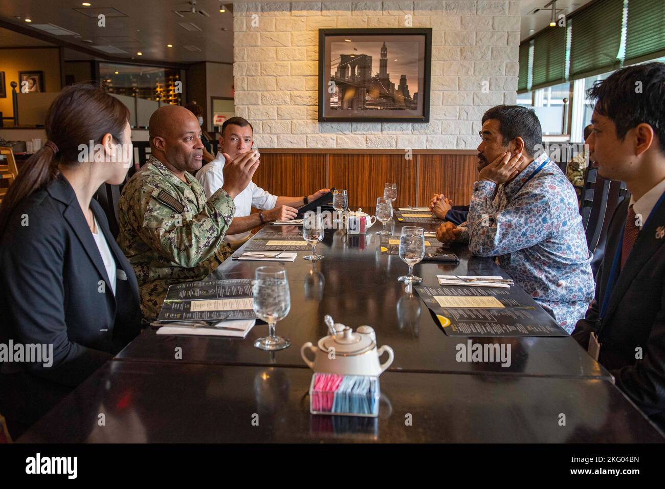 Capt. David Adams, Commander, Fleet Activities Sasebo (CFAS), converses ...