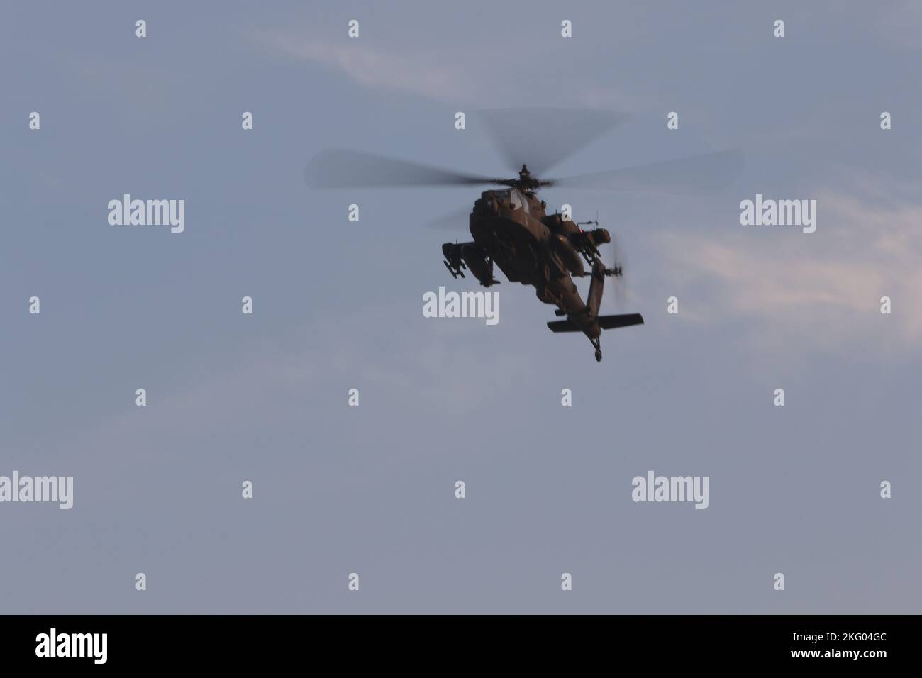 One of two U.S. Army AH-64E Apache helicopters conducts a flyover of ...
