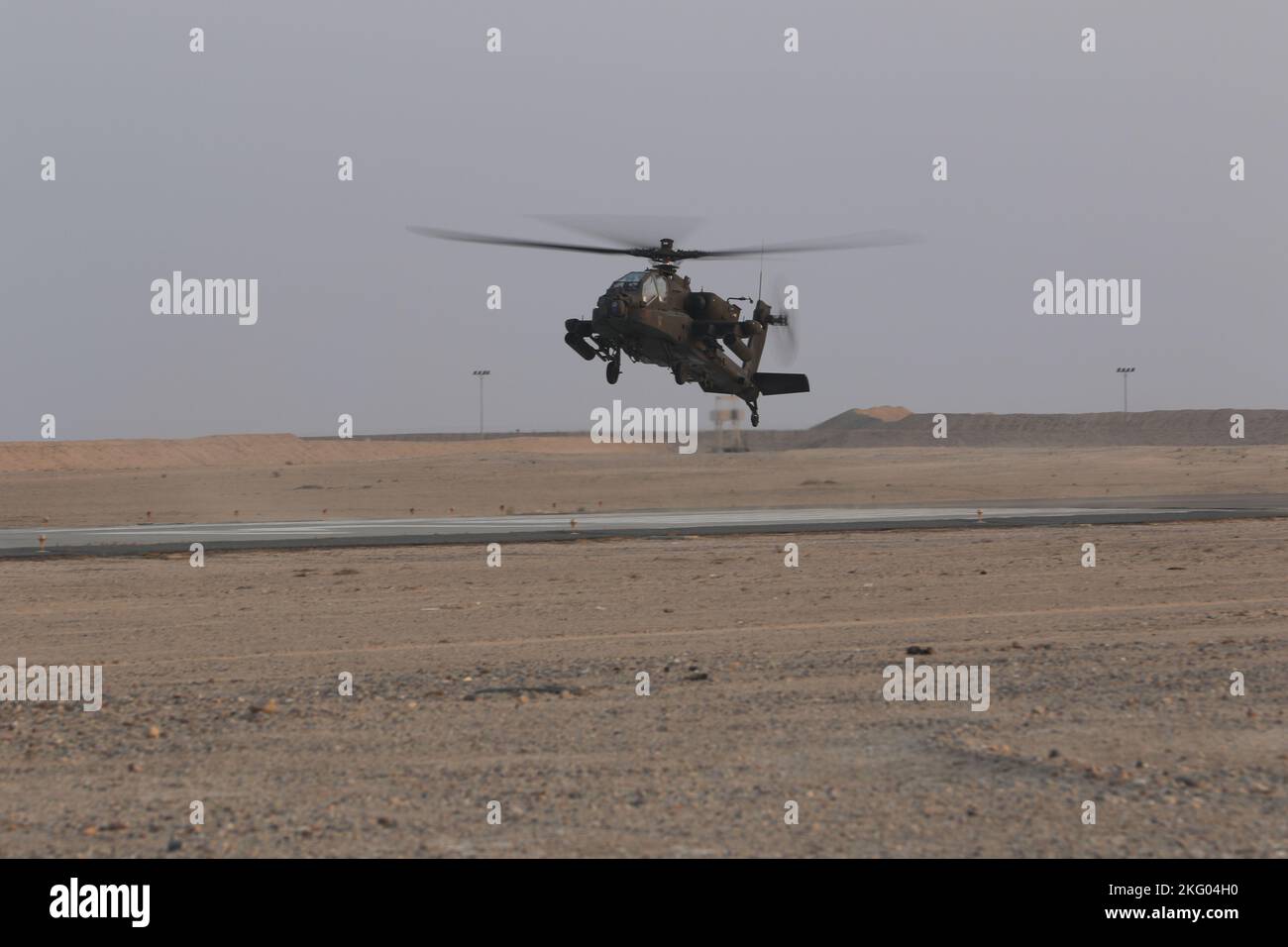 One of two U.S. Army AH-64E Apache helicopters conducts a brief landing ...