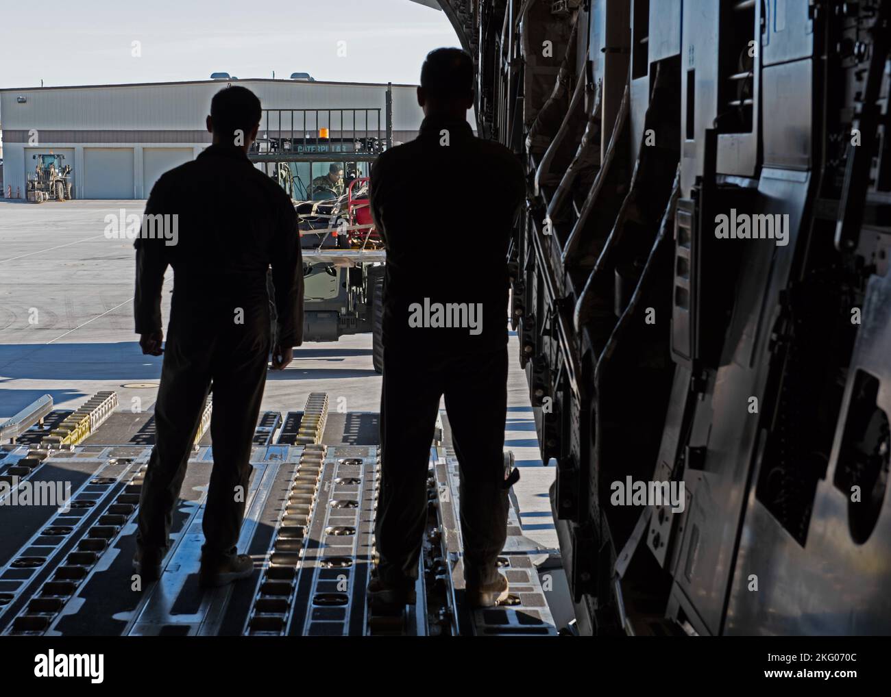 Loadmasters with the 7th Airlift Squadron prepare to load a pallet onto ...