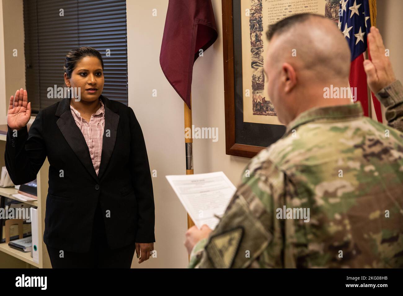 Army Capt. Sara Powell takes the oath of commissioned officers from ...