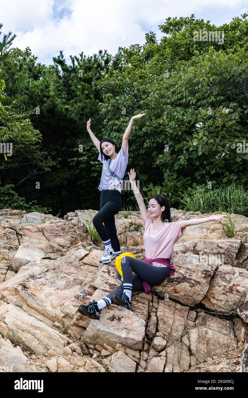 korean young women hiking and plogging hurray hand motion Stock Photo ...