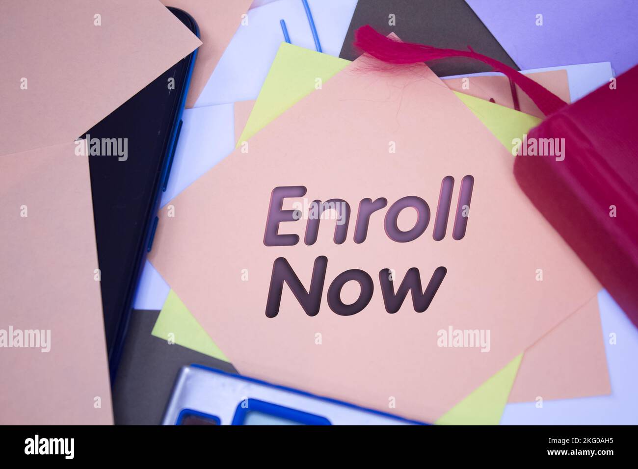 Enroll Now. Text on adhesive note paper. Event, celebration reminder ...