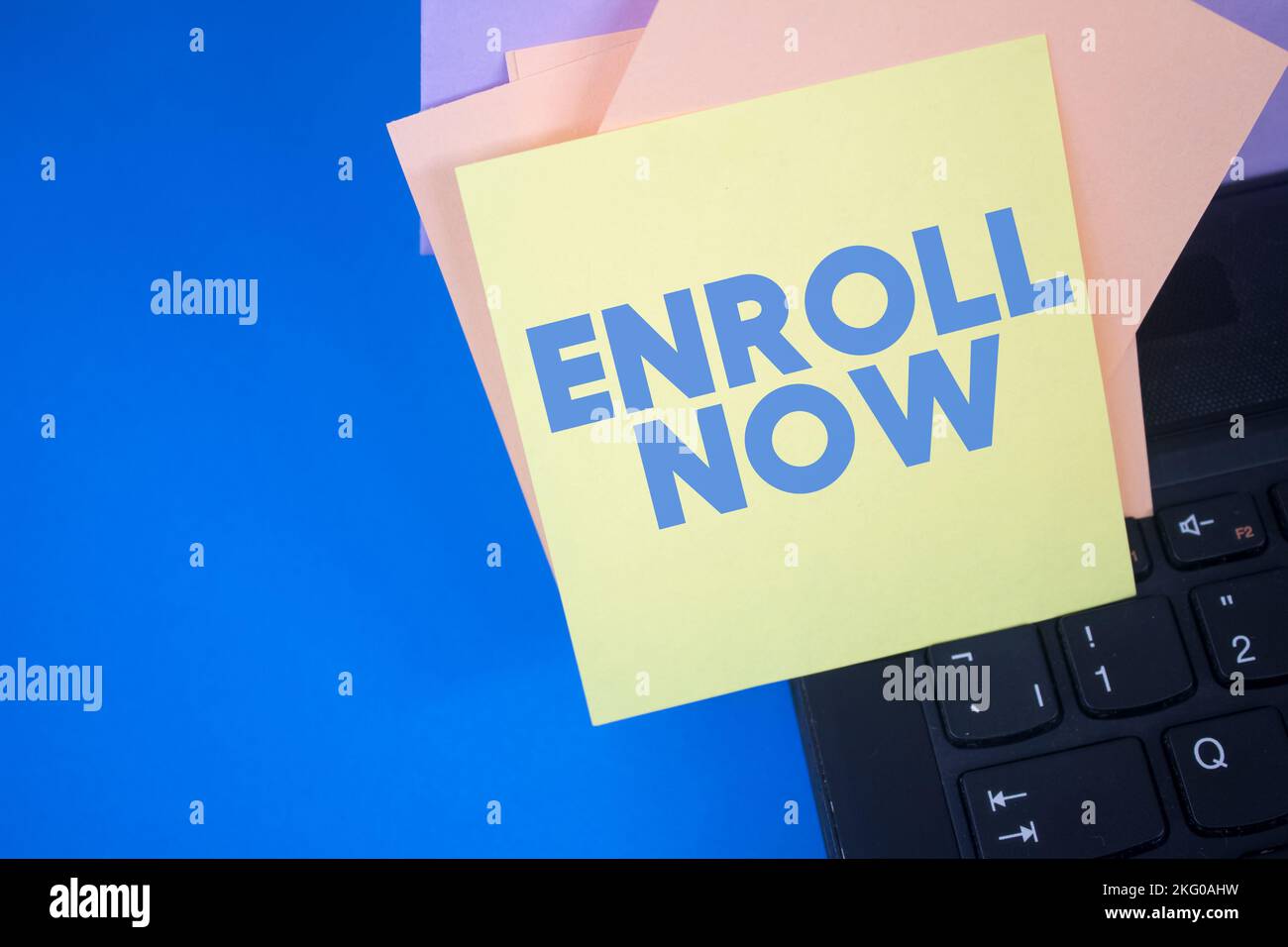 Enroll Now. Text on adhesive note paper. Event, celebration reminder ...