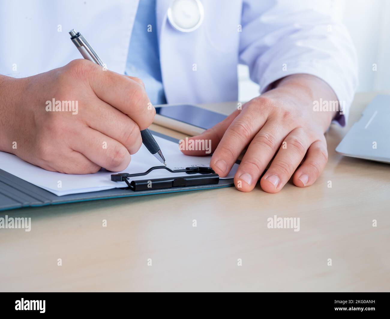 Close up pen in doctor hand on desk while he make a writing with a ...