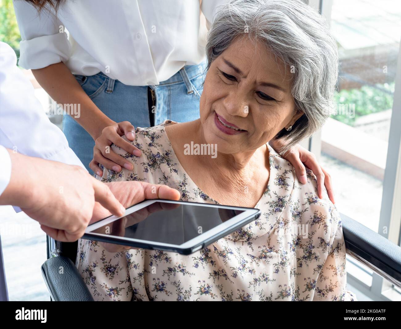 Portrait of smiling senior woman patients in wheelchair with assistant ...