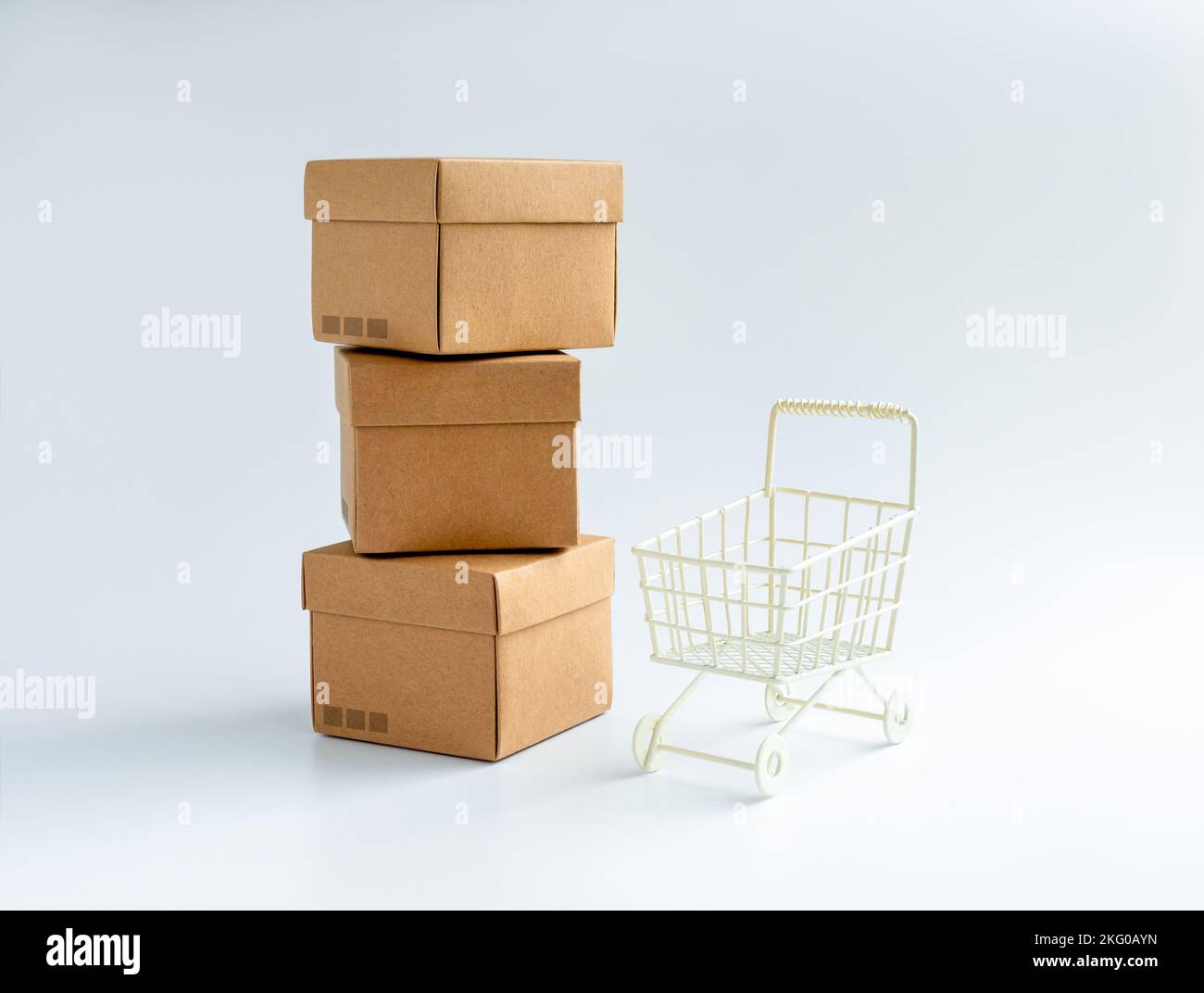 Cardboard parcel boxes stack and empty shopping trolley cart isolated ...