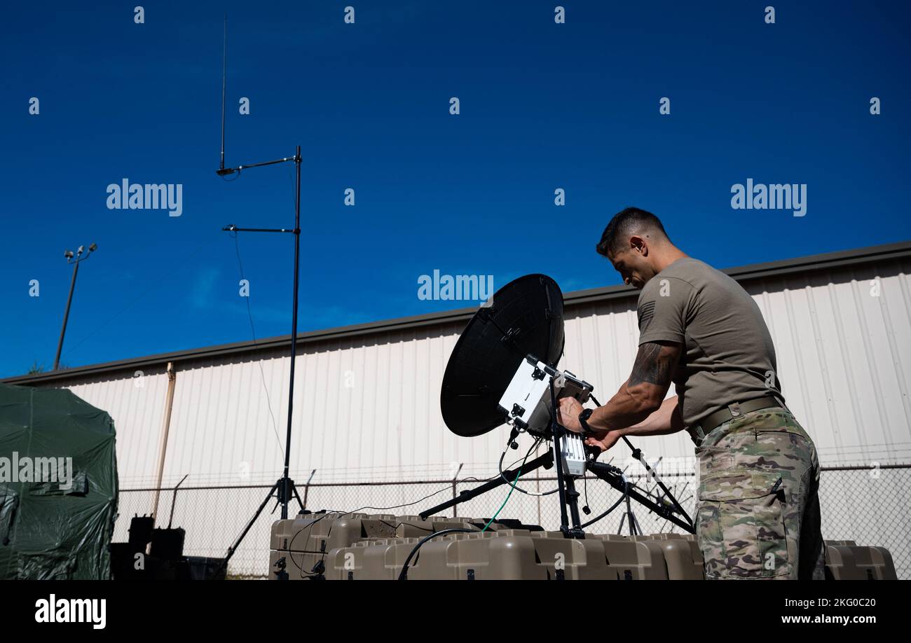 A Mission Support Radio airman angles a satellite dish for strongest ...
