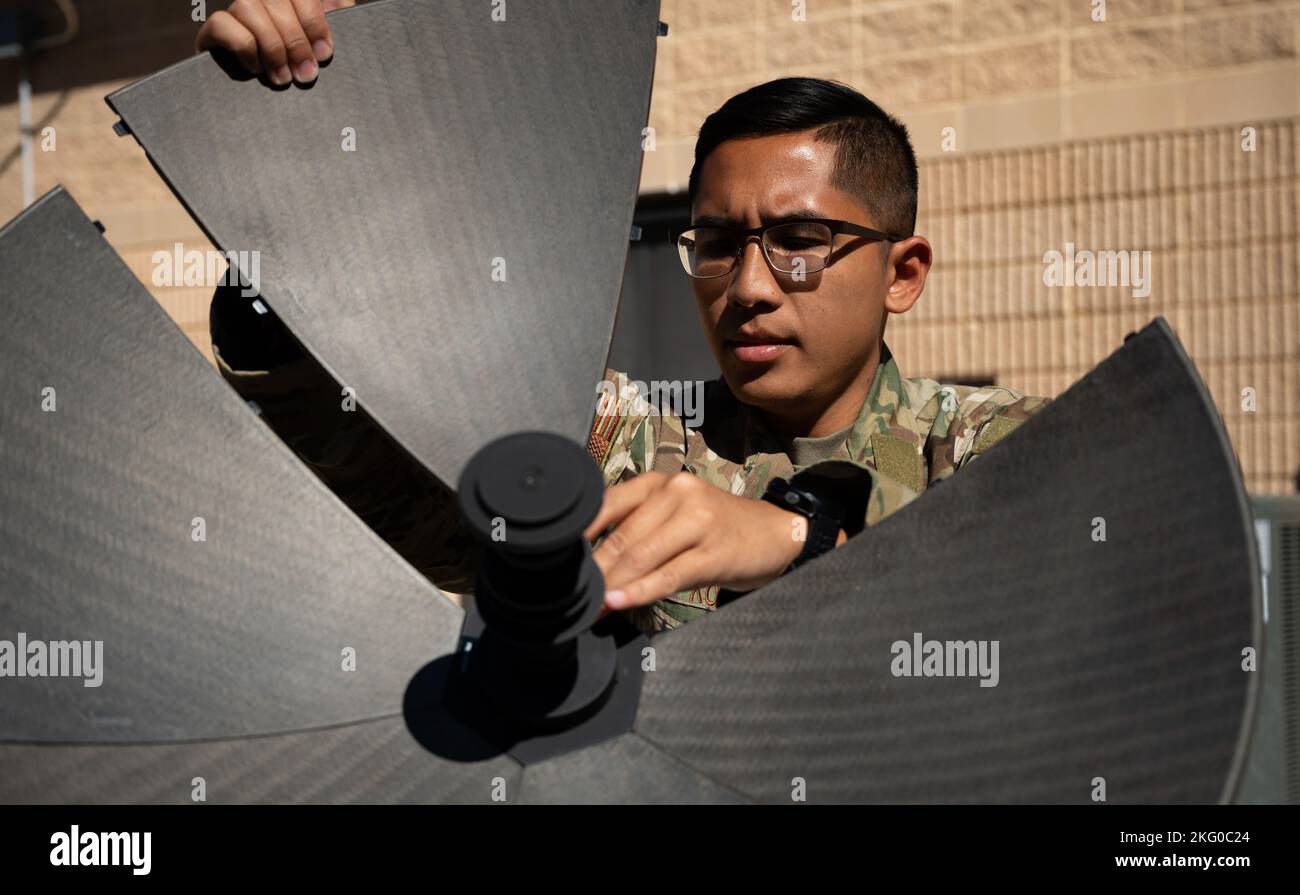 A Mission Support Radio airman assembles a satellite dish to receive ...