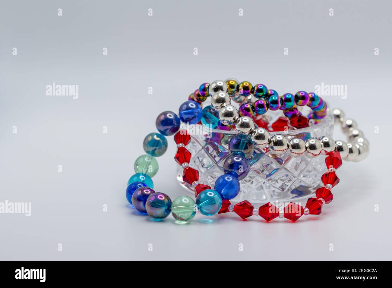 Macro abstract view of a small crystal bowl containing strings of ...