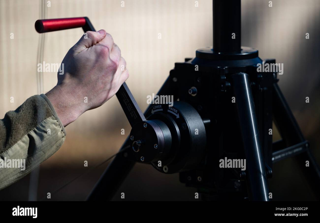 A Mission Support Radio airman cranks a line-of-sight radio antenna to ...