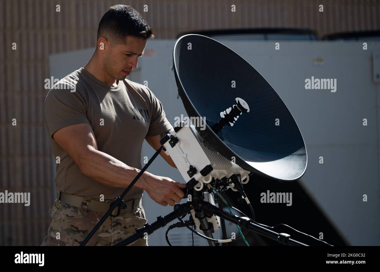 A Mission Support Radio airman secures a satellite dish to ensure ...