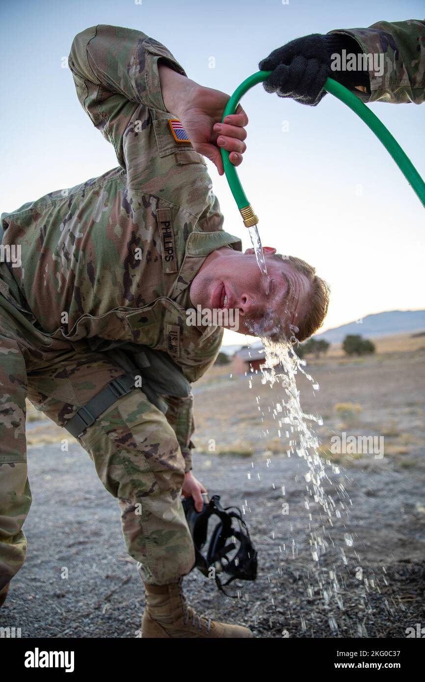 Spc. Logan Phillips with 97th Troop Command, rinses his eyes after ...